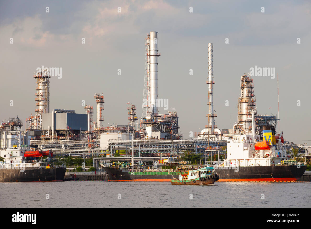 oil refinery and tanker ship on port in heavy industry use for energy ...