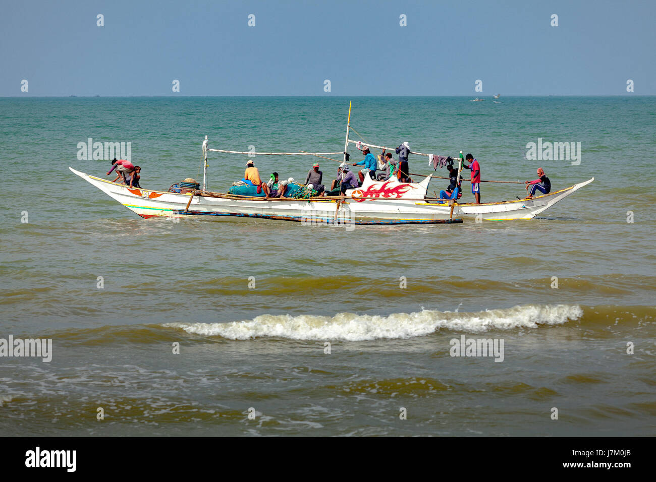 Filipino crew of a fishing boat, bangka, head out to sea off Baybay ...