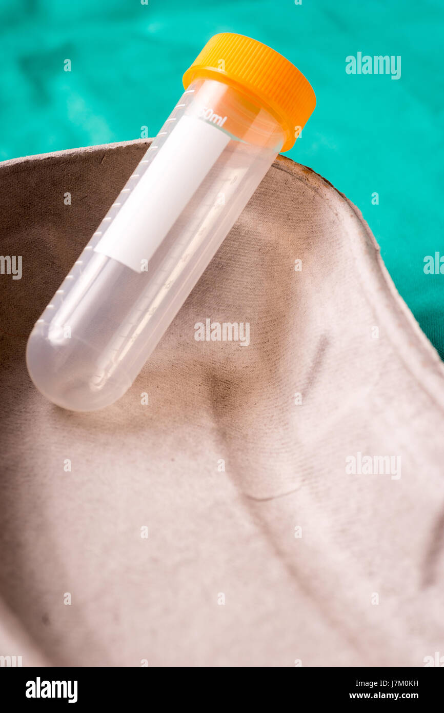 Medical test tube lying in a one use capsule on the hospital's green ...