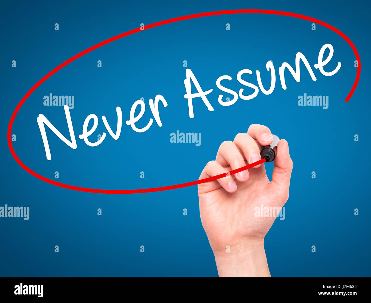 Man Hand writing Never Assume with black marker on visual screen ...