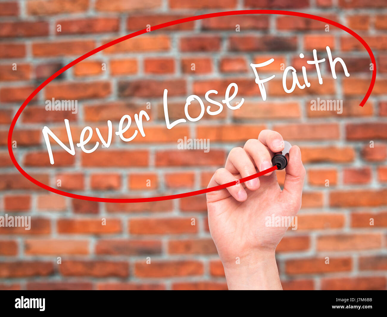 Man Hand writing Never Lose Faith with black marker on visual screen ...