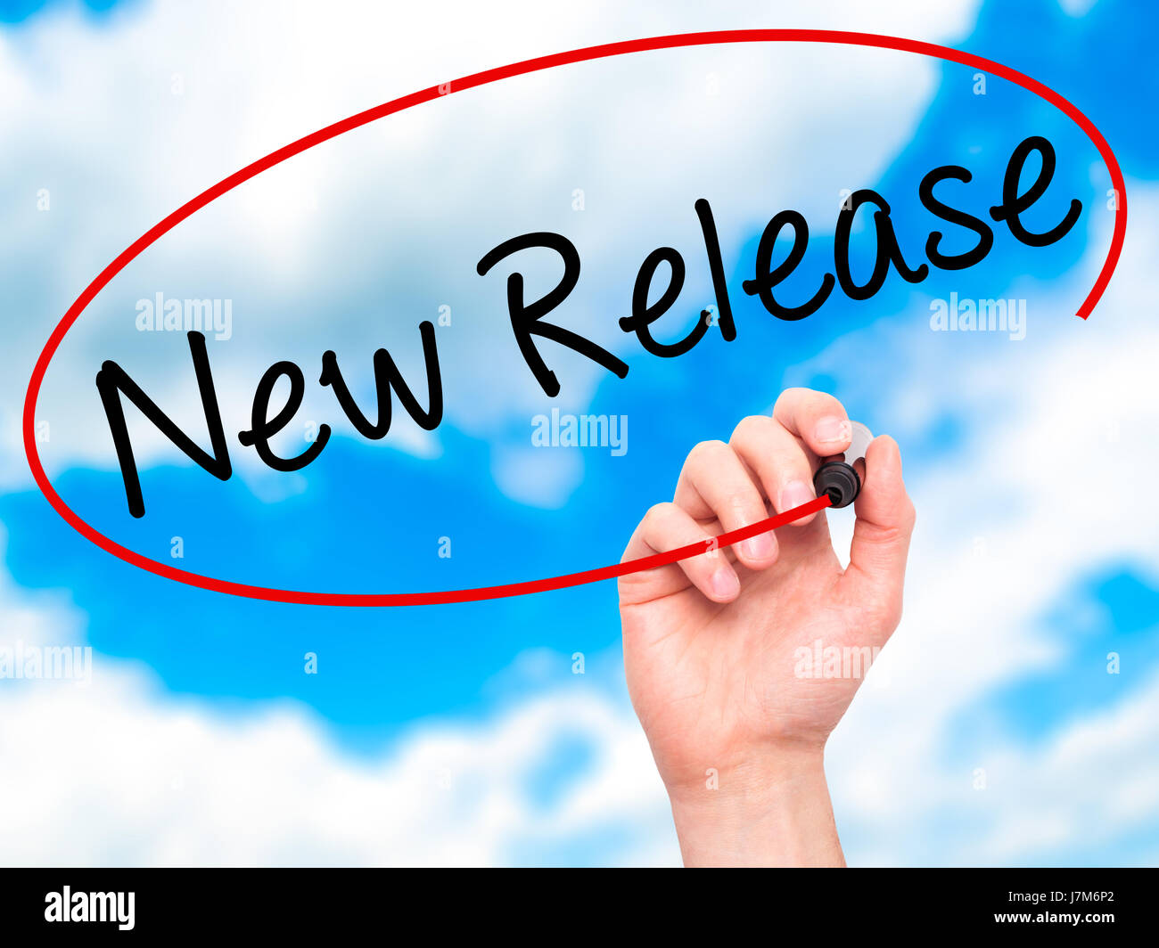Man Hand writing New Release with black marker on visual screen ...