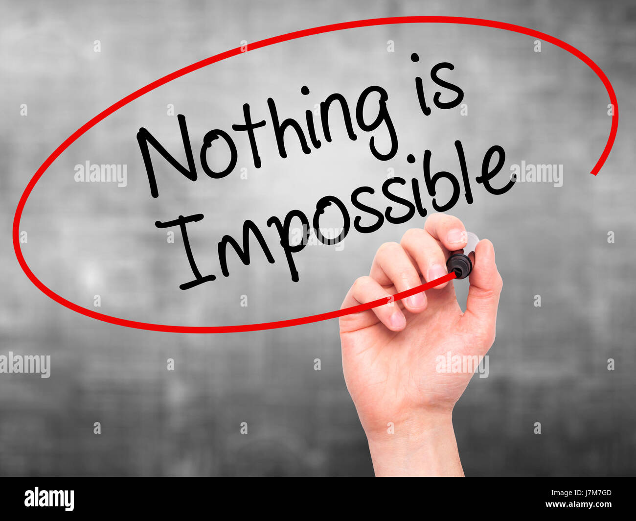 Man Hand writing Nothing is Impossible with black marker on visual ...