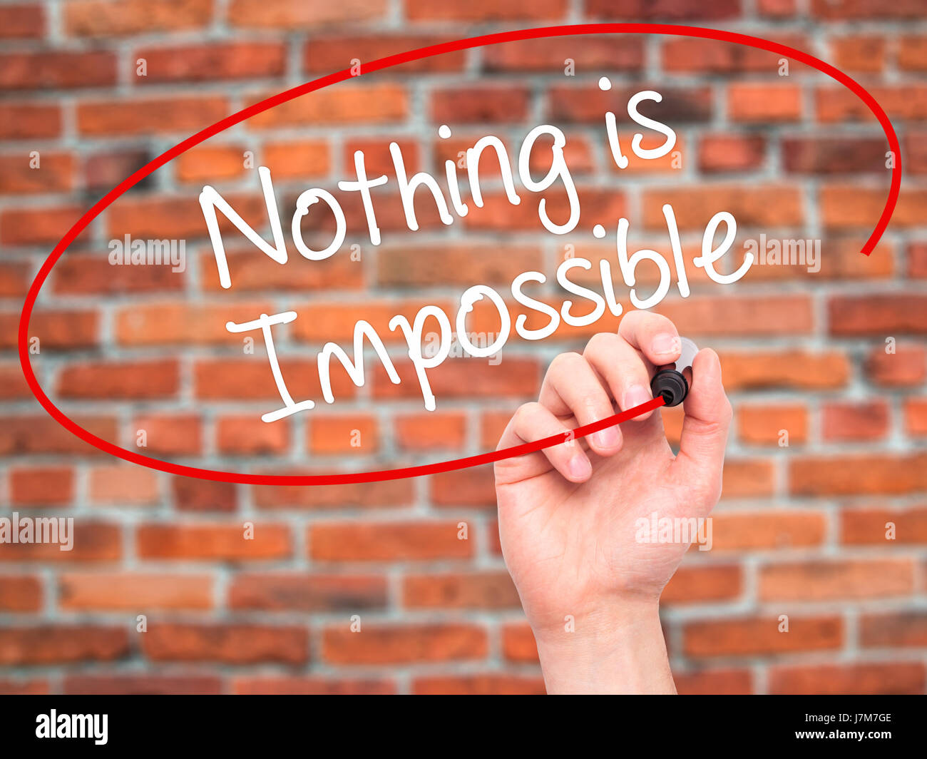 Man Hand writing Nothing is Impossible with black marker on visual ...