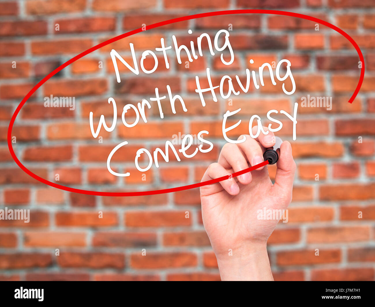 Man Hand writing Nothing Worth Having Comes Easy with black marker on ...