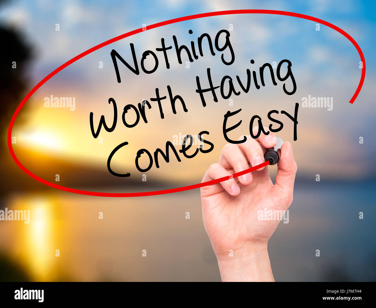 Man Hand writing Nothing Worth Having Comes Easy with black marker on ...