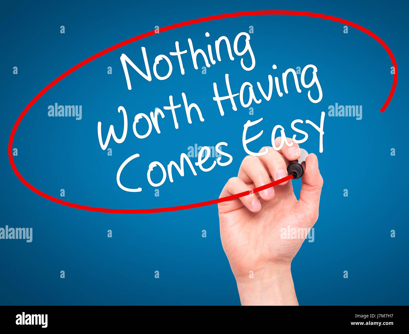 Man Hand writing Nothing Worth Having Comes Easy with black marker on ...
