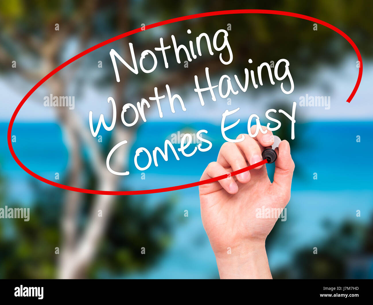 Man Hand writing Nothing Worth Having Comes Easy with black marker on ...