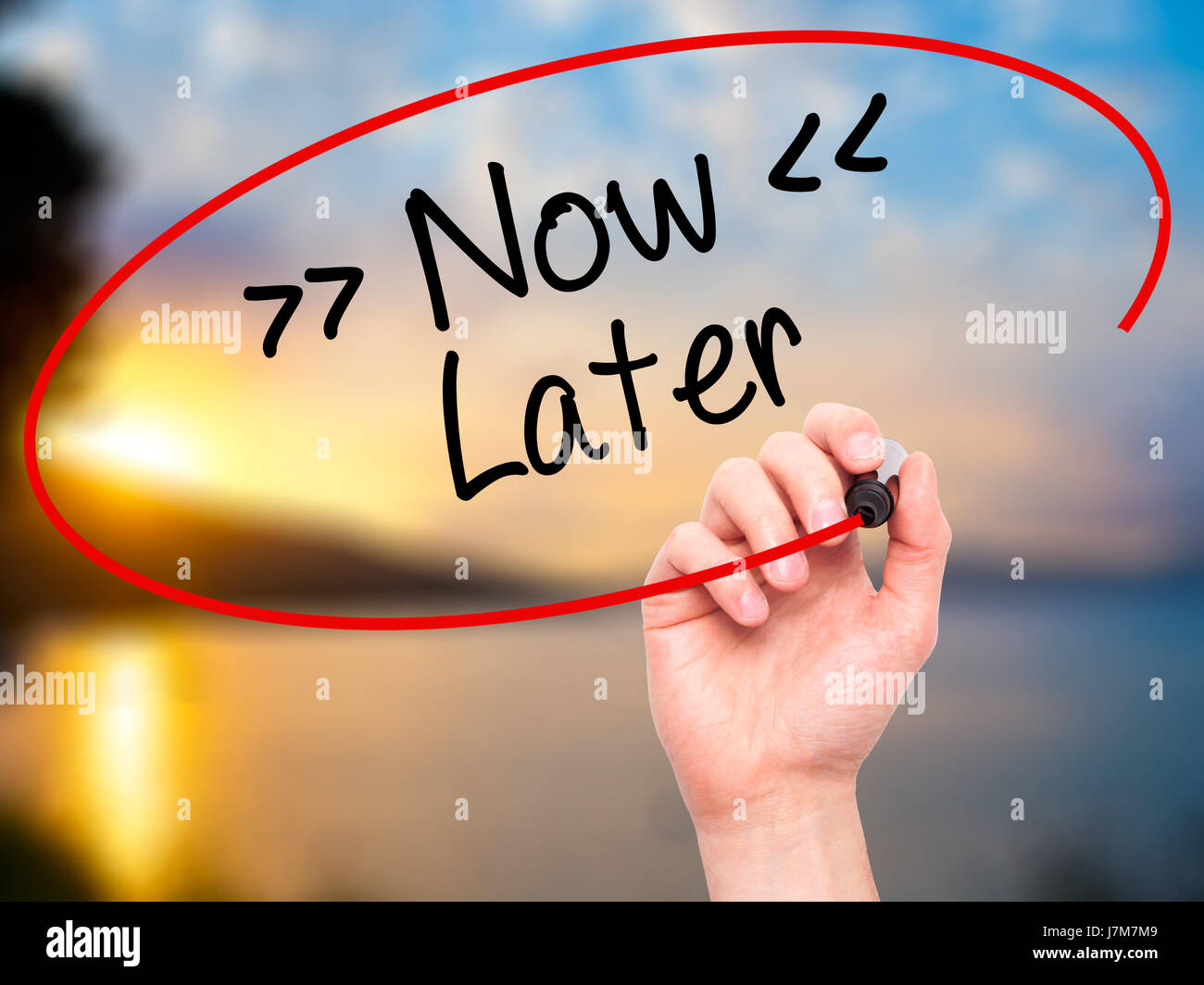 Man Hand writing Now/Later with black marker on visual screen. Isolated ...