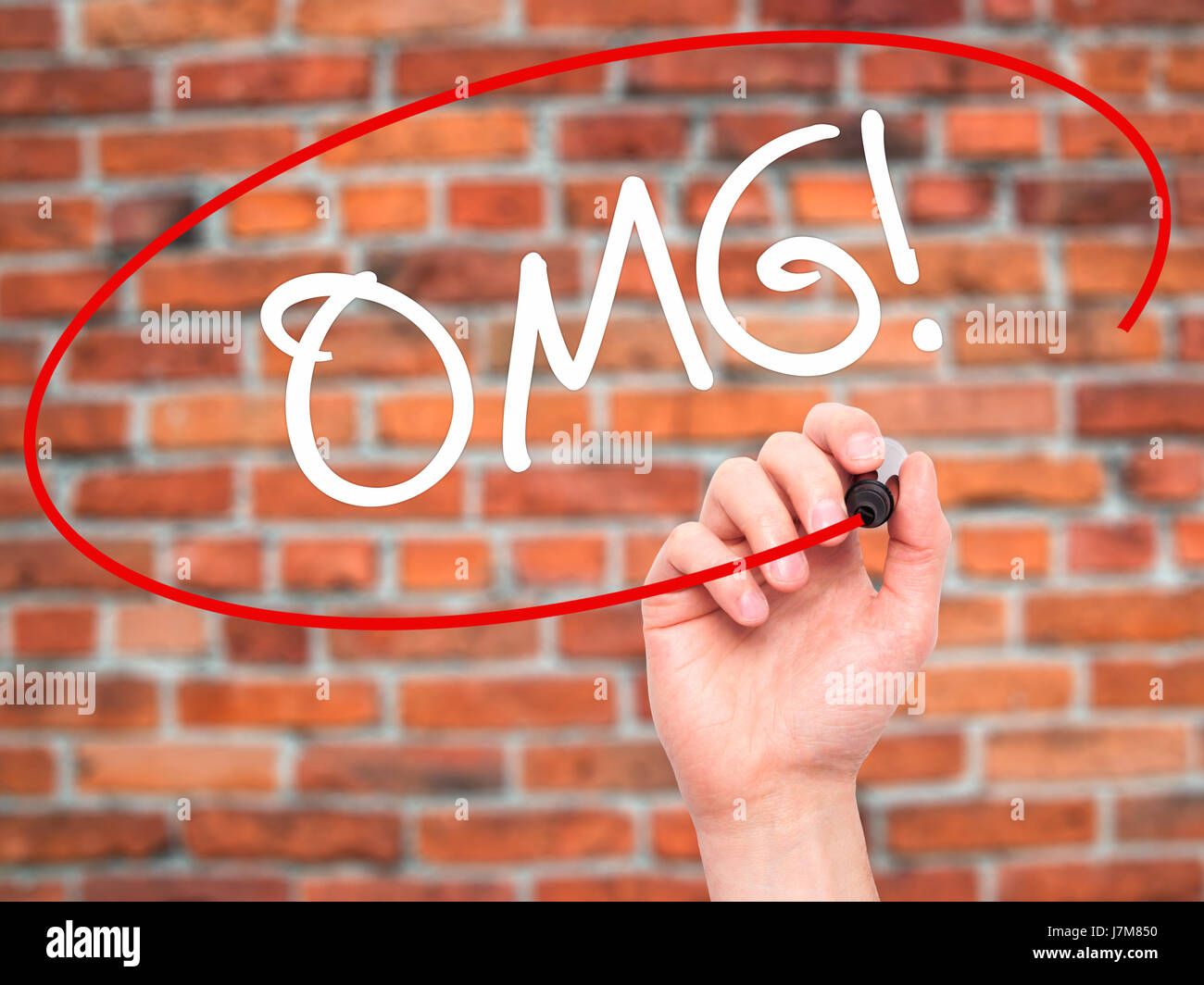 Man Hand writing OMG (Oh My God) with black marker on visual screen ...