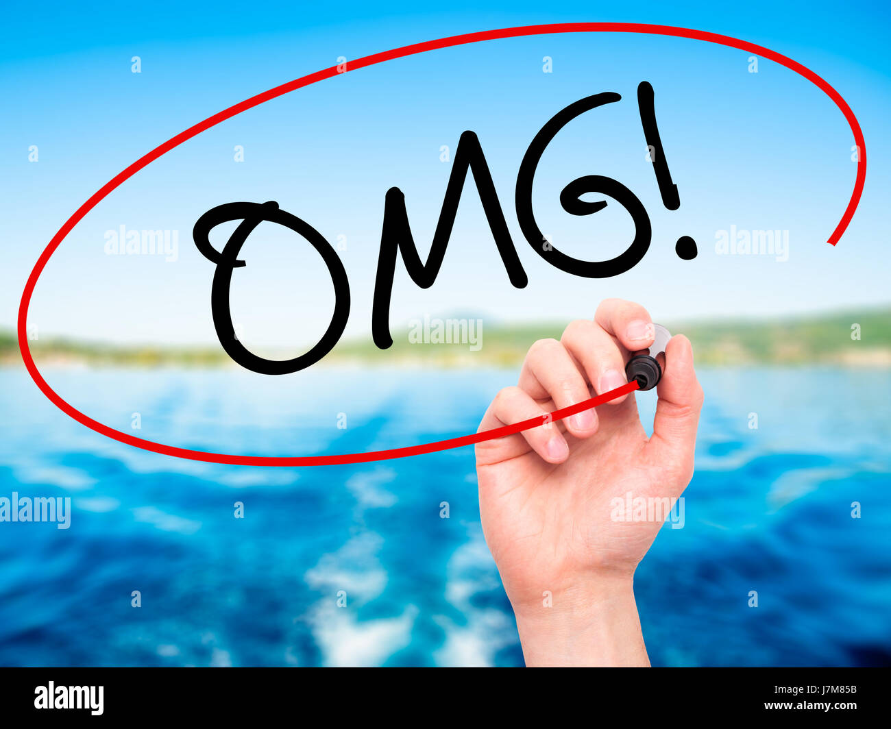 Man Hand writing OMG (Oh My God) with black marker on visual screen ...