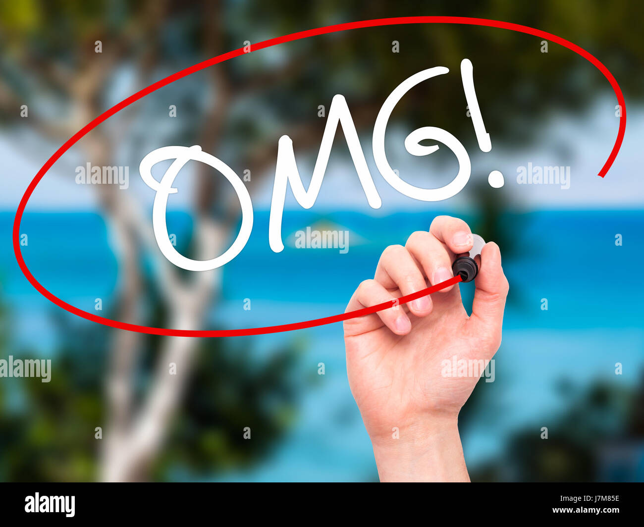 Man Hand writing OMG (Oh My God) with black marker on visual screen ...