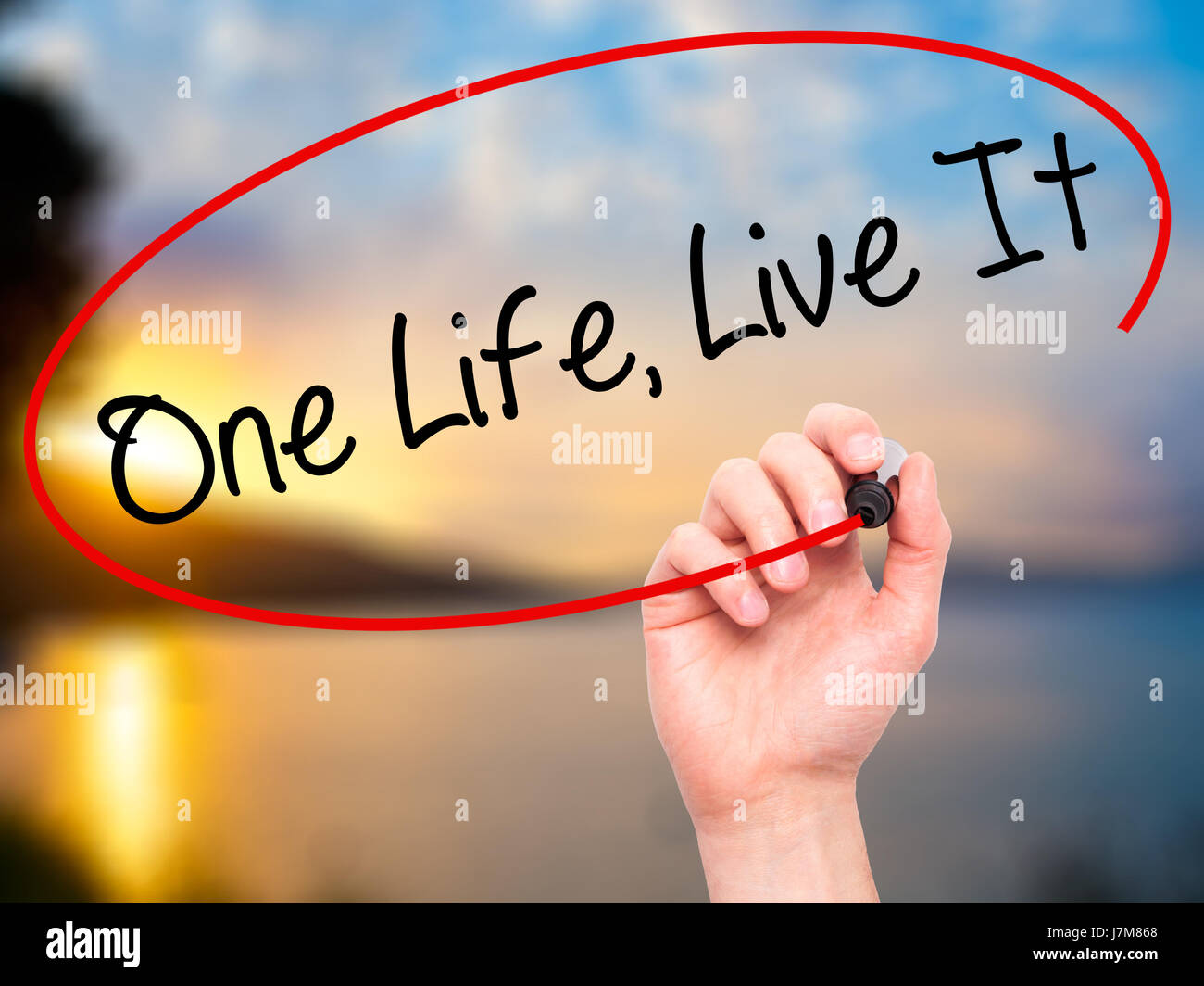 Man Hand writing One Life Live It with black marker on visual screen ...