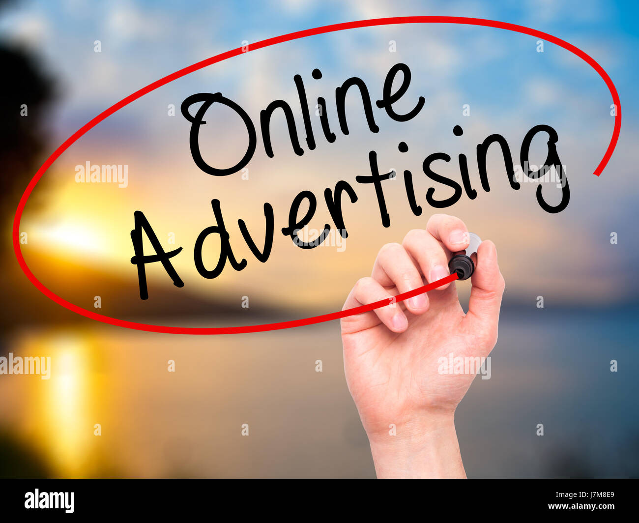 Man Hand writing Online Advertising with black marker on visual screen ...