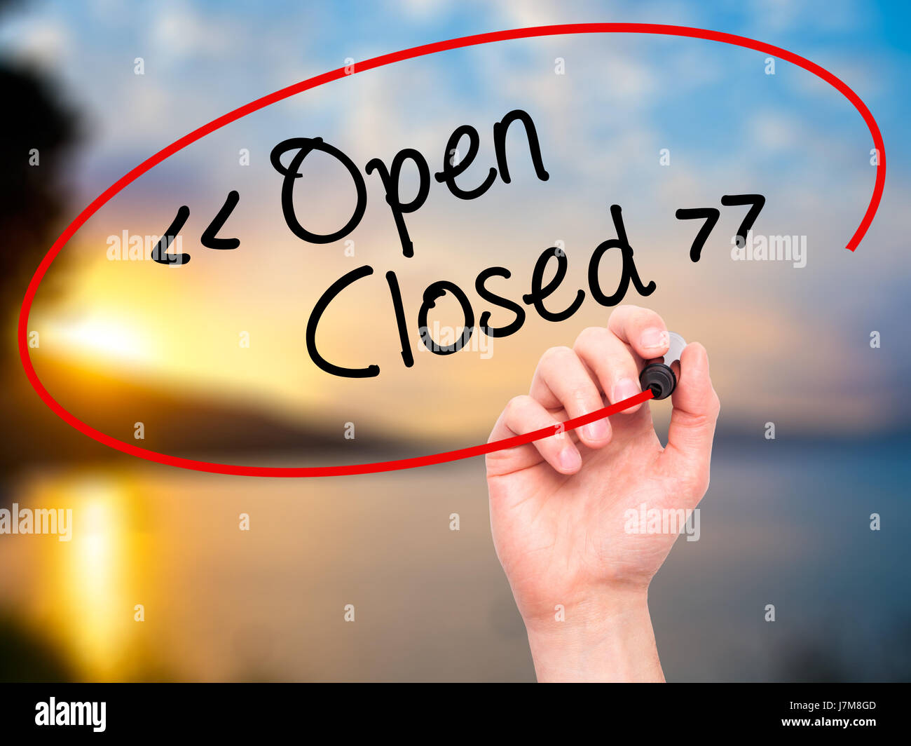 Man Hand writing Open - Closed with black marker on visual screen ...