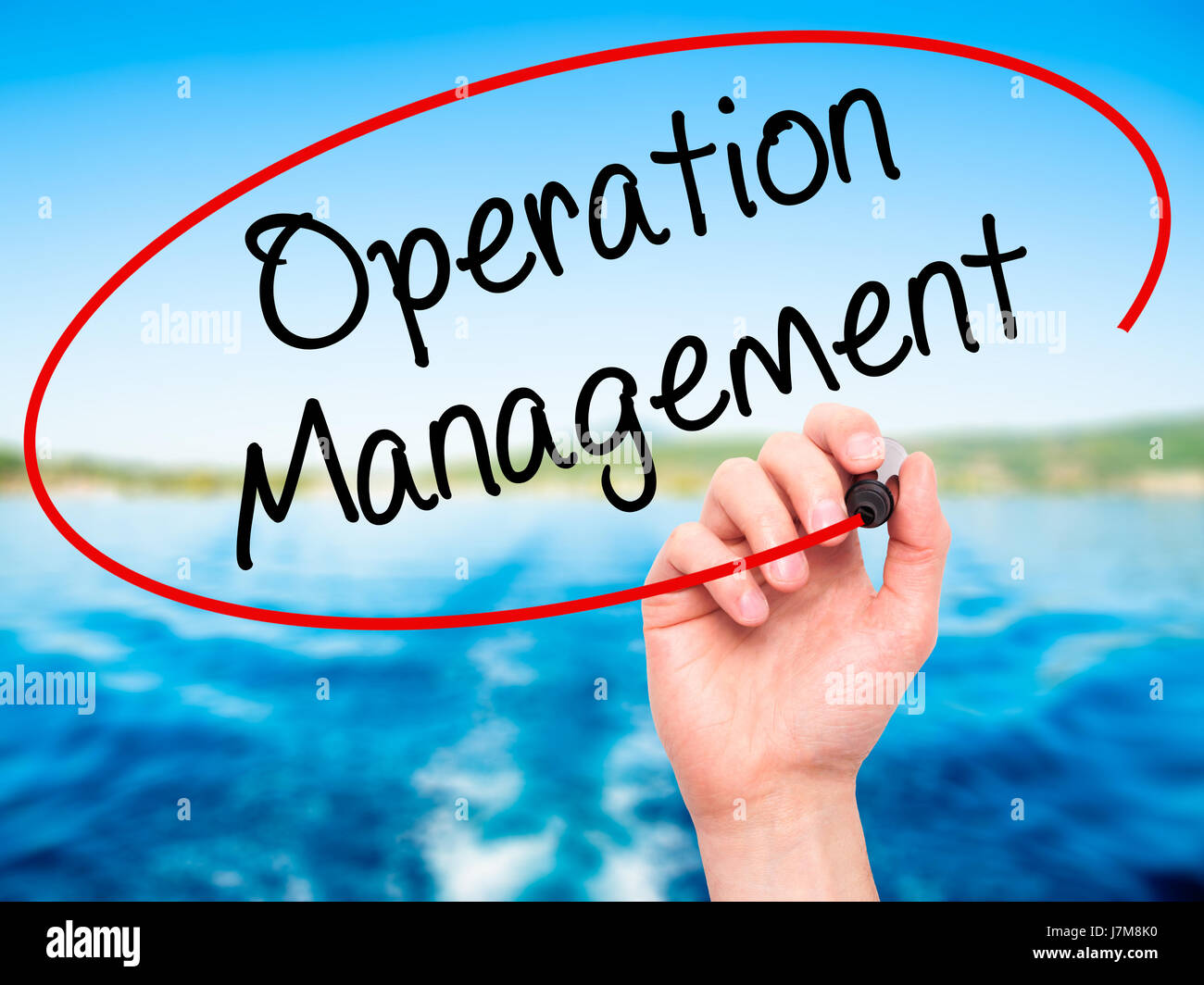 Man Hand writing Operation Management with black marker on visual ...