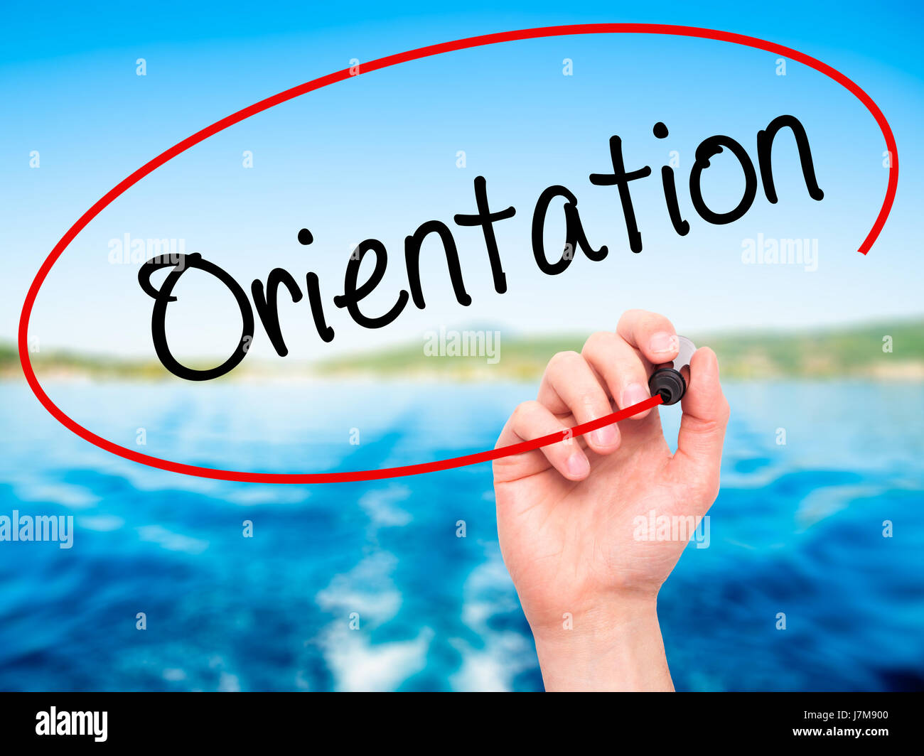 Man Hand writing Orientation with black marker on visual screen ...