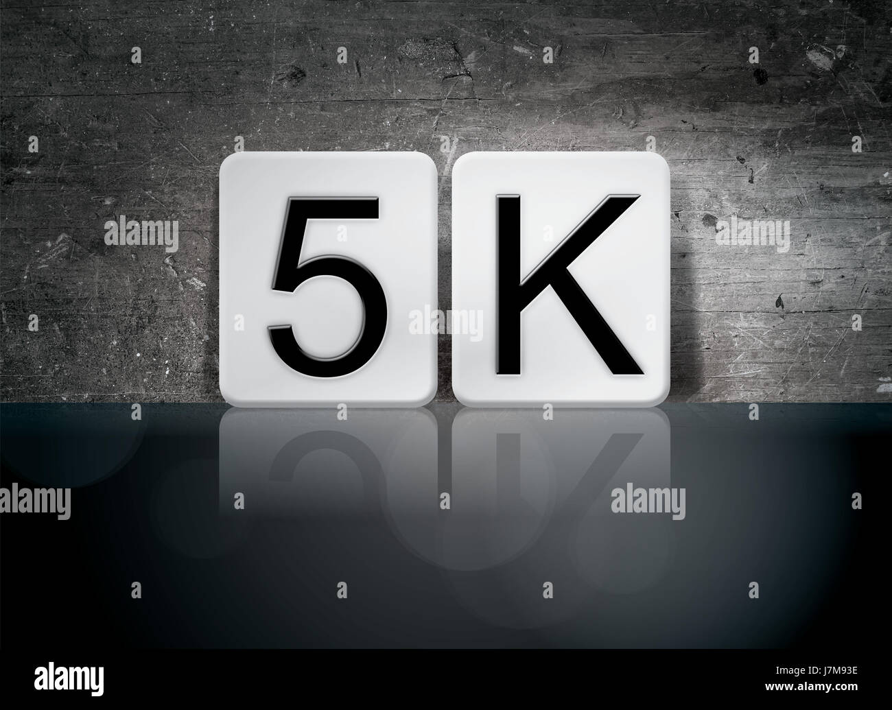 The word 5K concept and theme written in white tiles on a dark ...