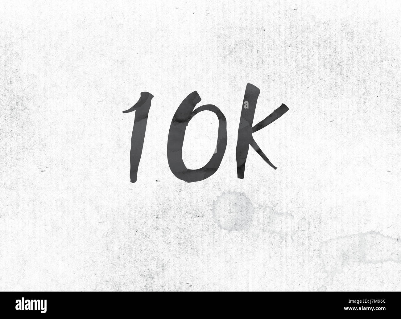 The word 10K concept and theme painted in black ink on a watercolor ...