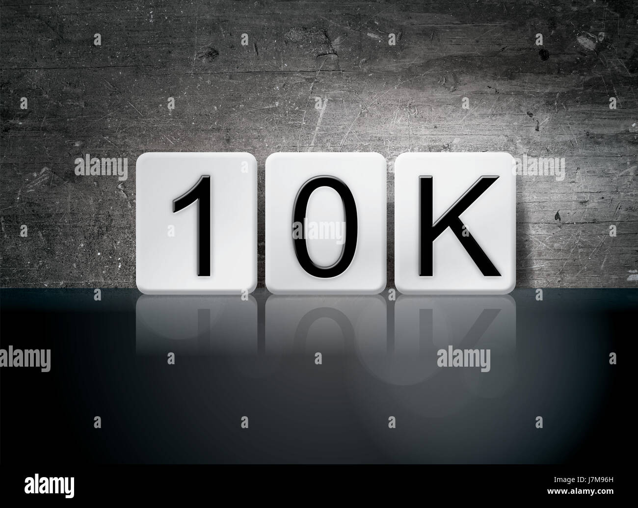 The word 10K concept and theme written in white tiles on a dark ...