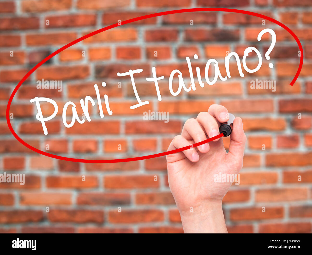 Man Hand writing Parli Italiano? with black marker on visual screen ...