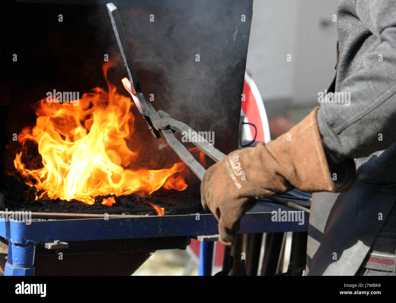 hand fire conflagration glow blacksmith pliers tongs hand iron steel ...