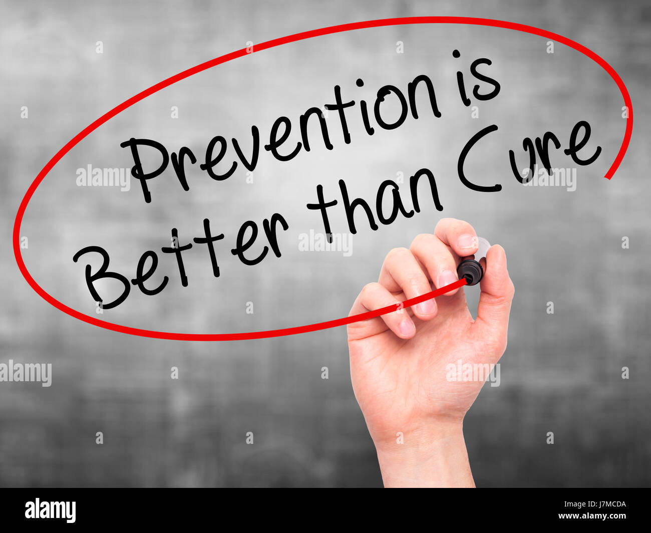 Man Hand writing Prevention is Better than Cure with black marker on ...