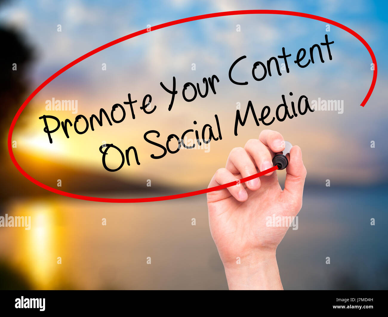 Man Hand writing Promote Your Content On Social Media with black marker ...