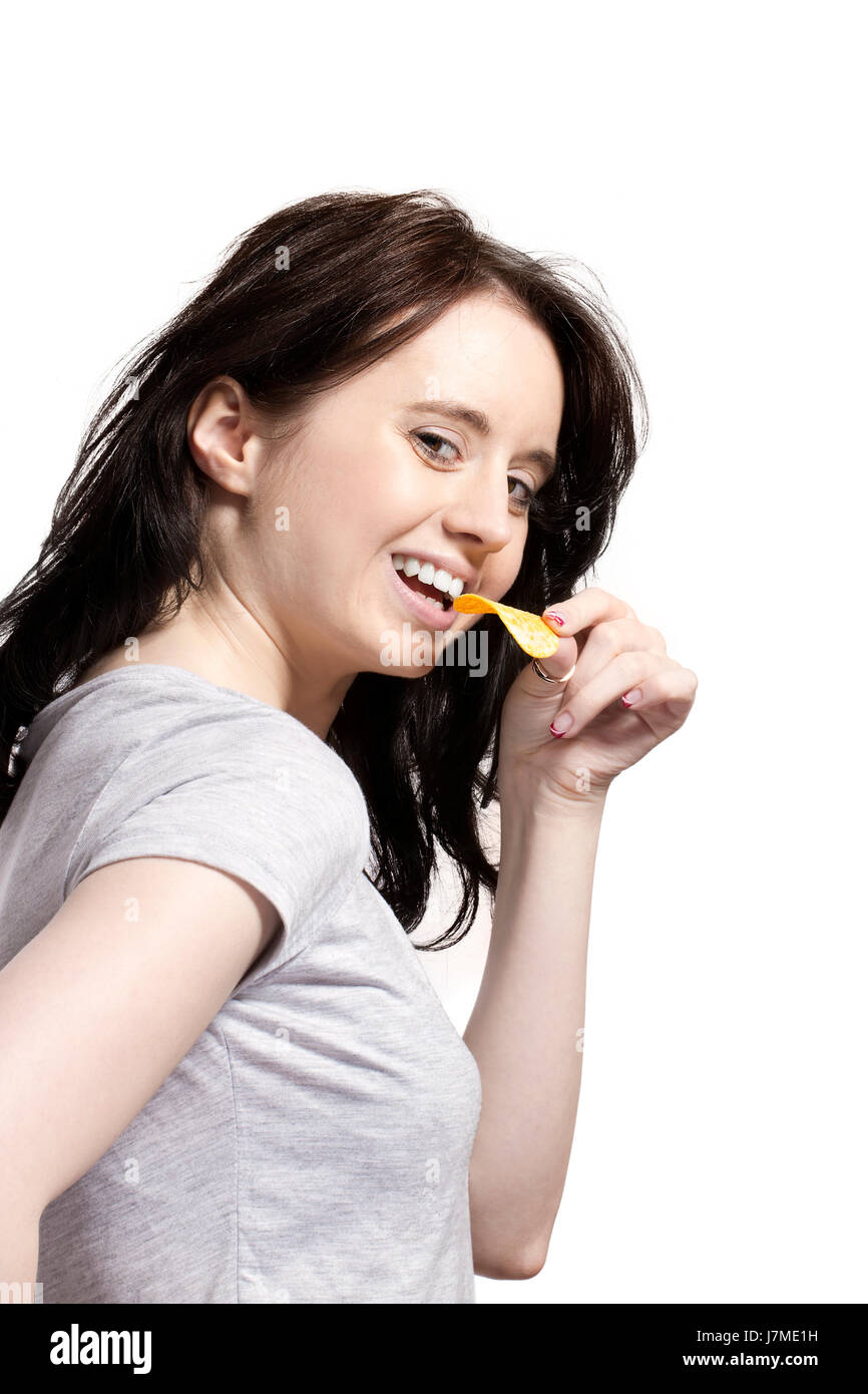 young woman nibbling on potato chip Stock Photo - Alamy