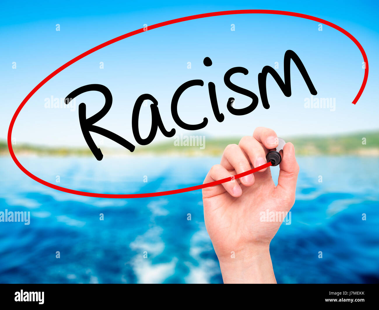 Man Hand writing Racism with black marker on visual screen. Isolated on ...