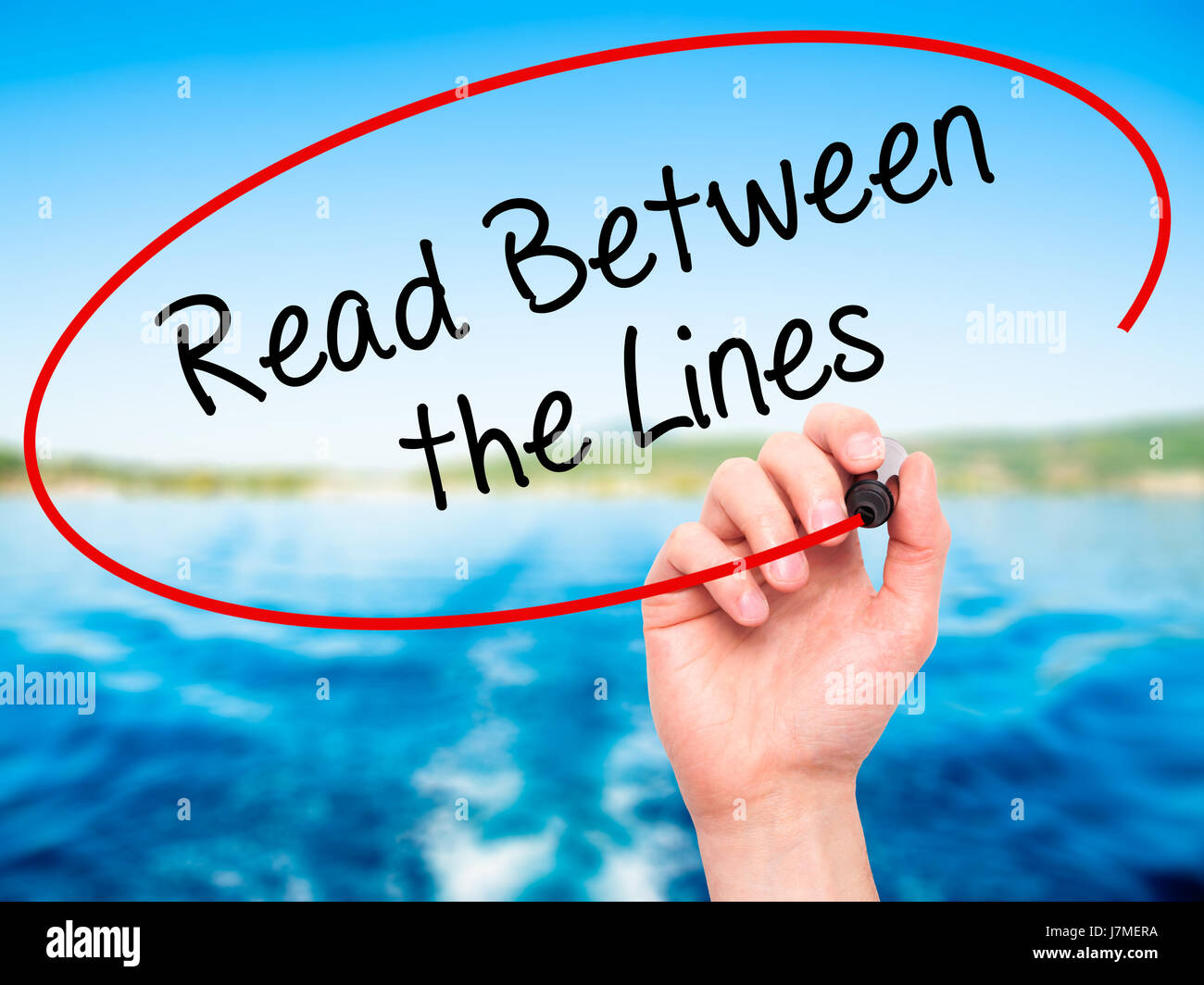 Man Hand writing Read Between the Lines with black marker on visual ...