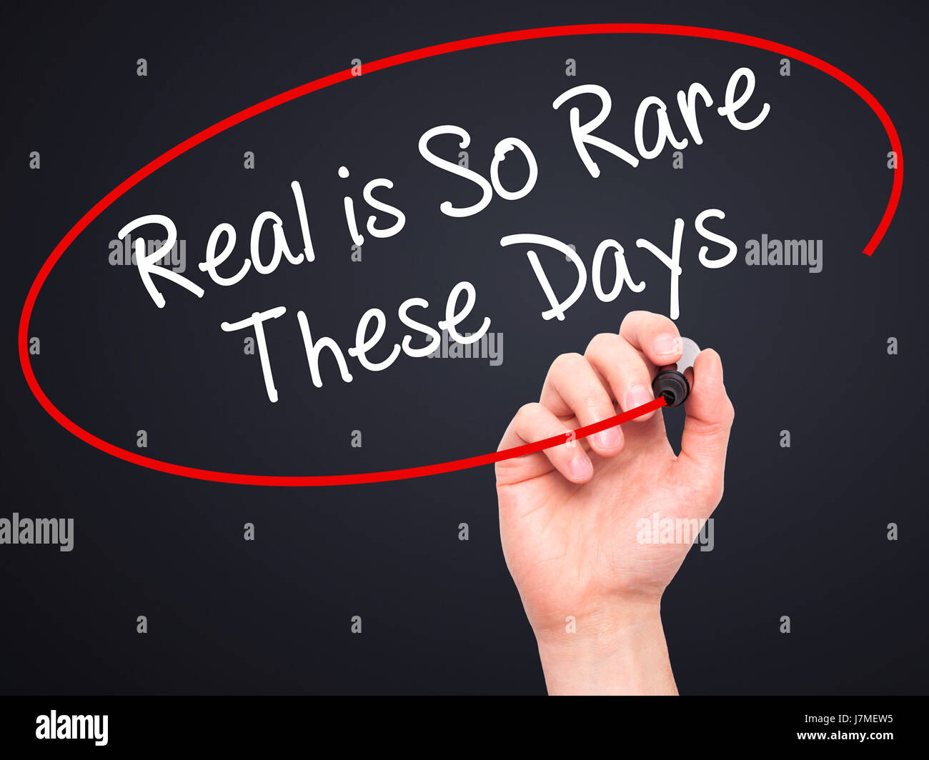 Man Hand writing Real is So Rare These Days with black marker on visual ...