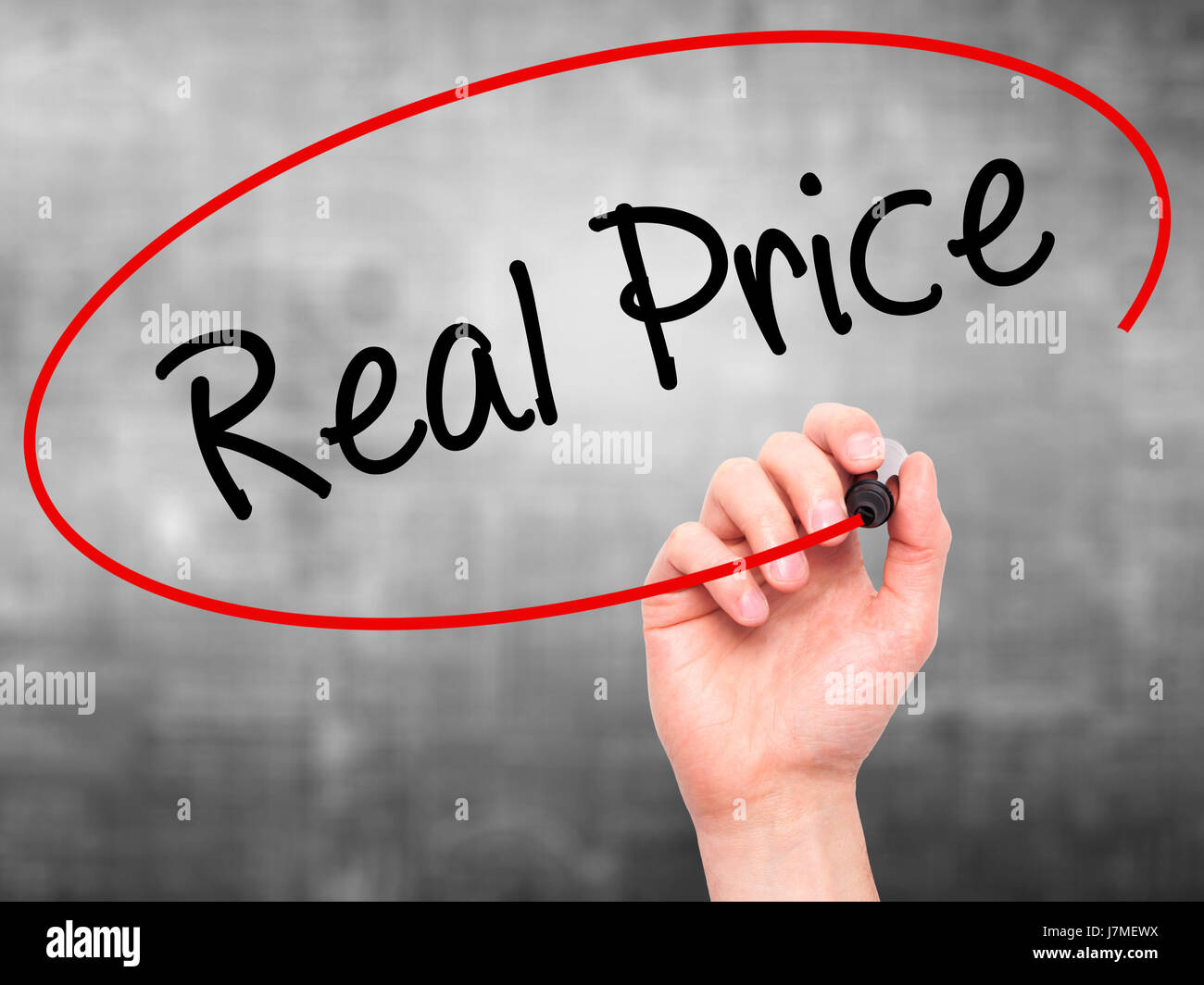 Man Hand writing Real Price with black marker on visual screen ...
