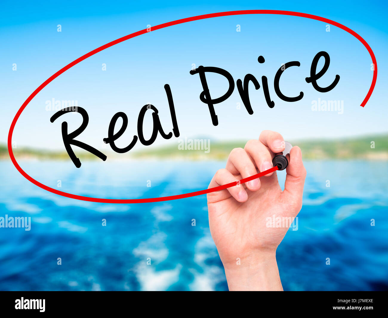 Man Hand writing Real Price with black marker on visual screen ...