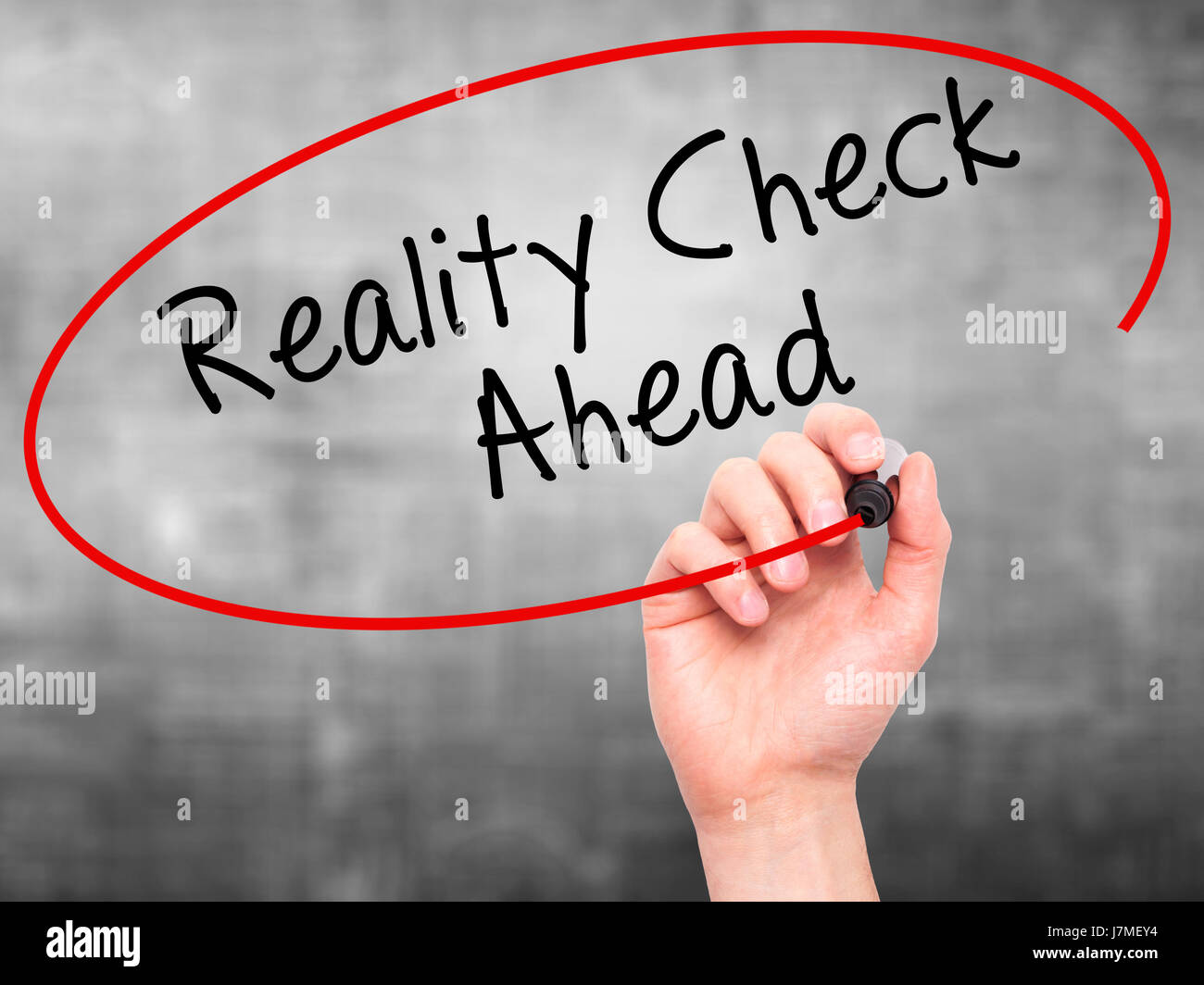 Man Hand writing Reality Check Ahead with black marker on visual screen. Isolated on grey ...
