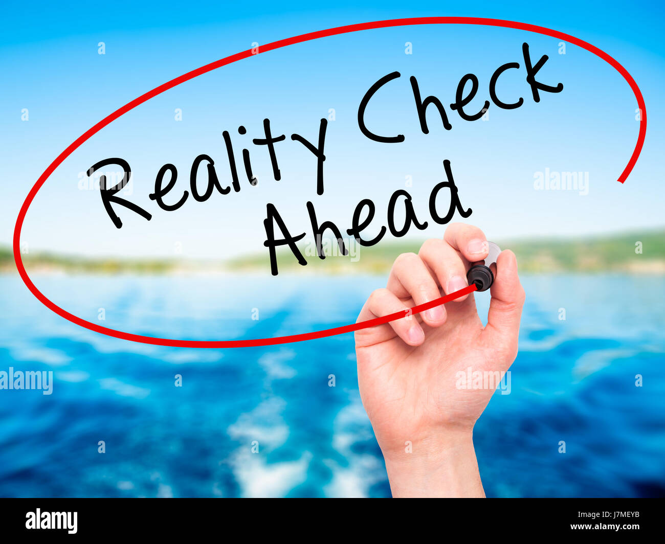 Man Hand writing Reality Check Ahead with black marker on visual screen ...