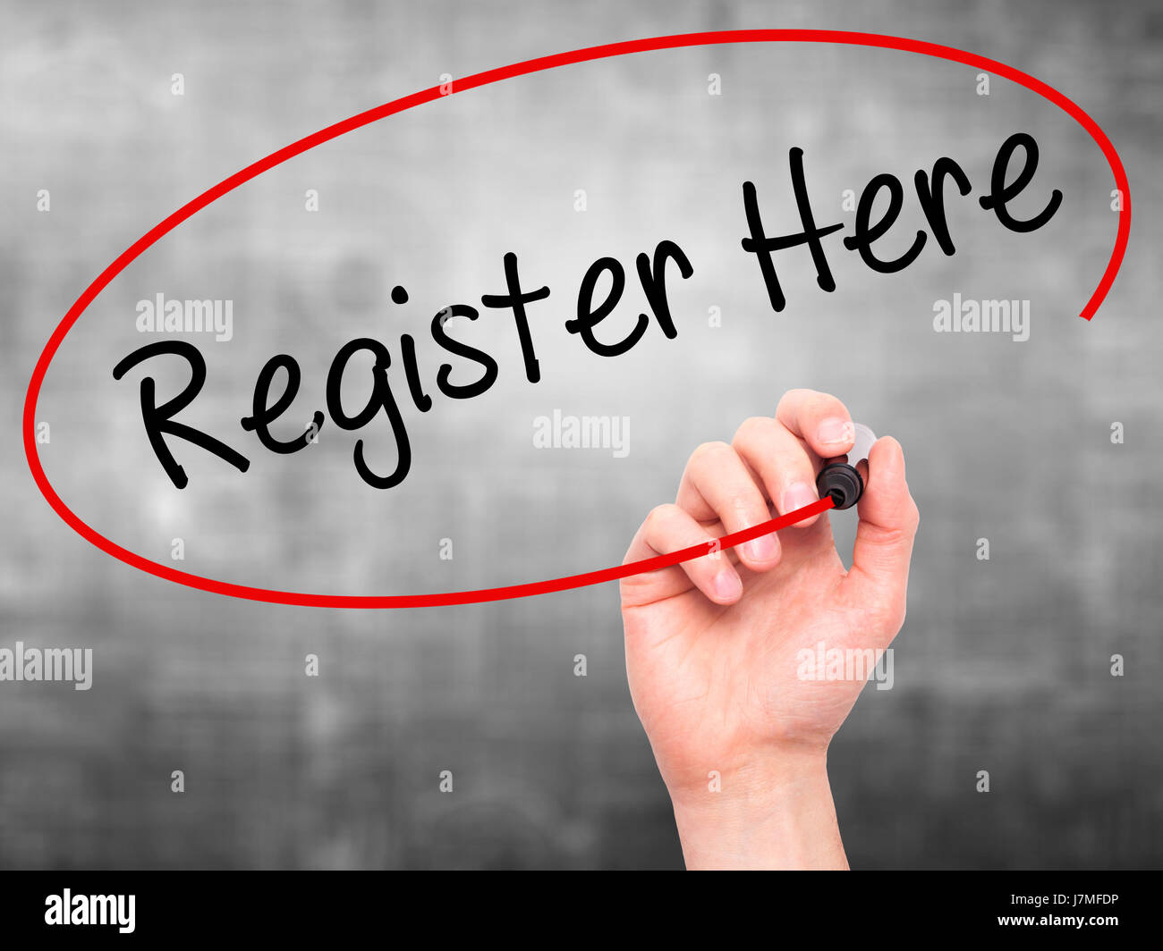 Man Hand writing Register Here with black marker on visual screen ...