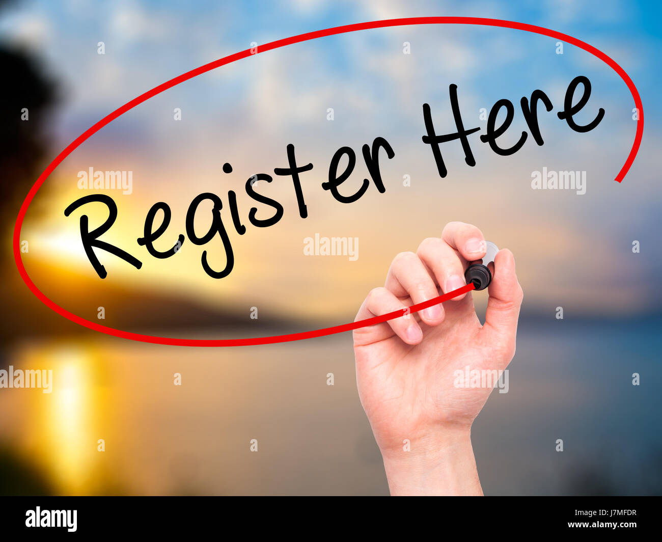 Man Hand writing Register Here with black marker on visual screen ...