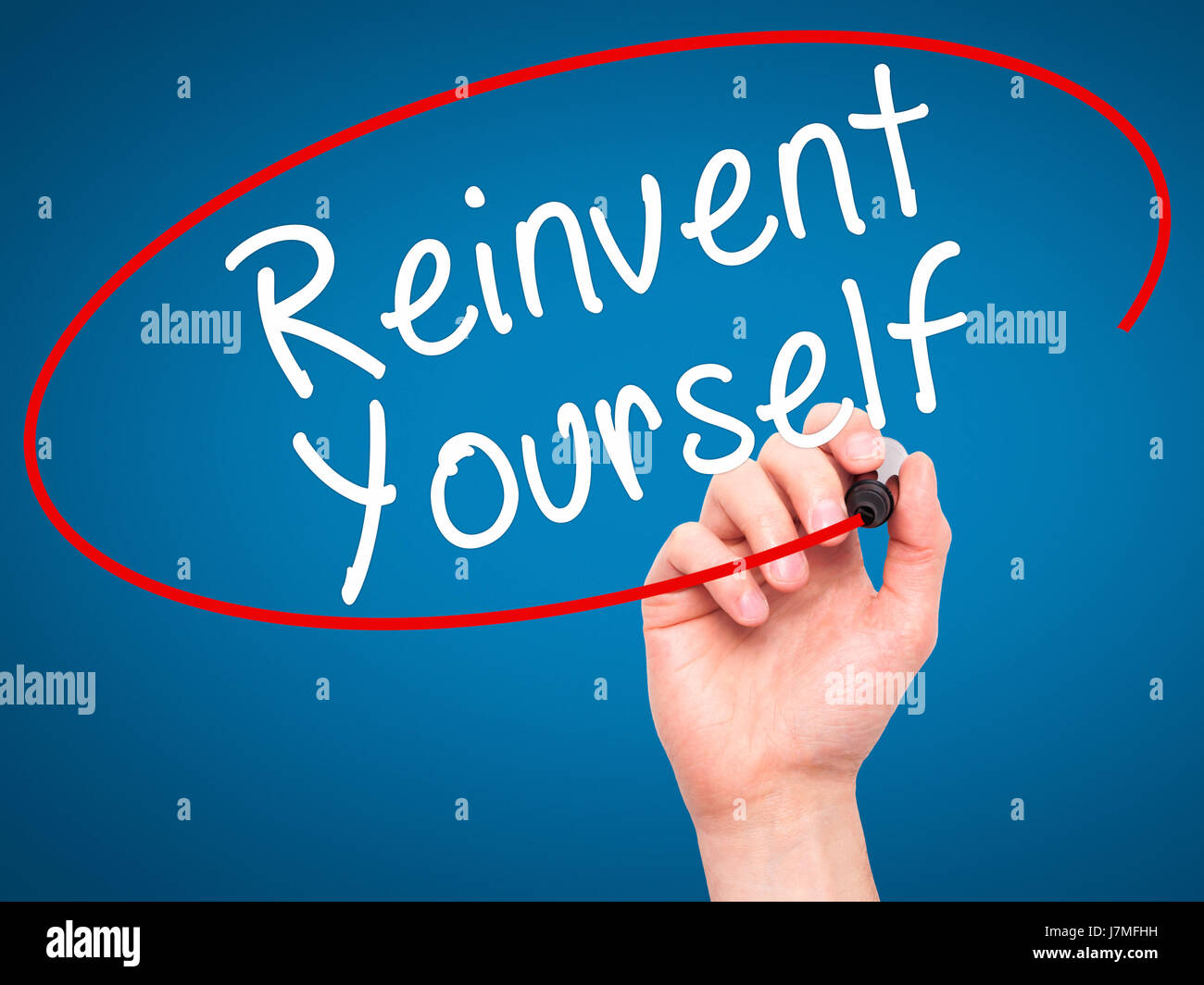 Man Hand writing Reinvent Yourself with black marker on visual screen ...