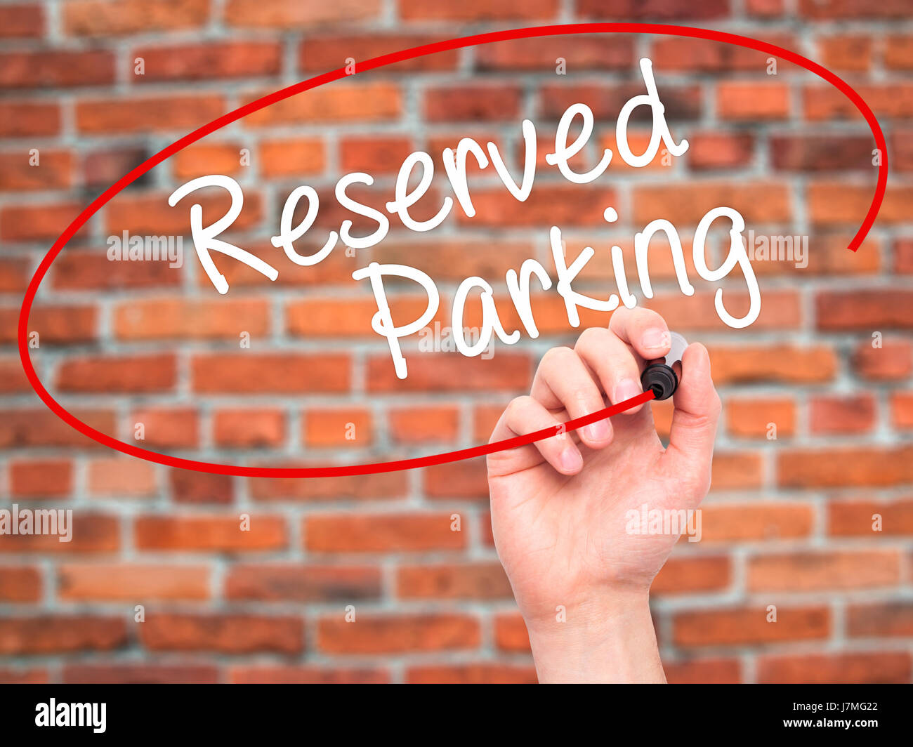 Man Hand writing Reserved Parking with black marker on visual screen ...