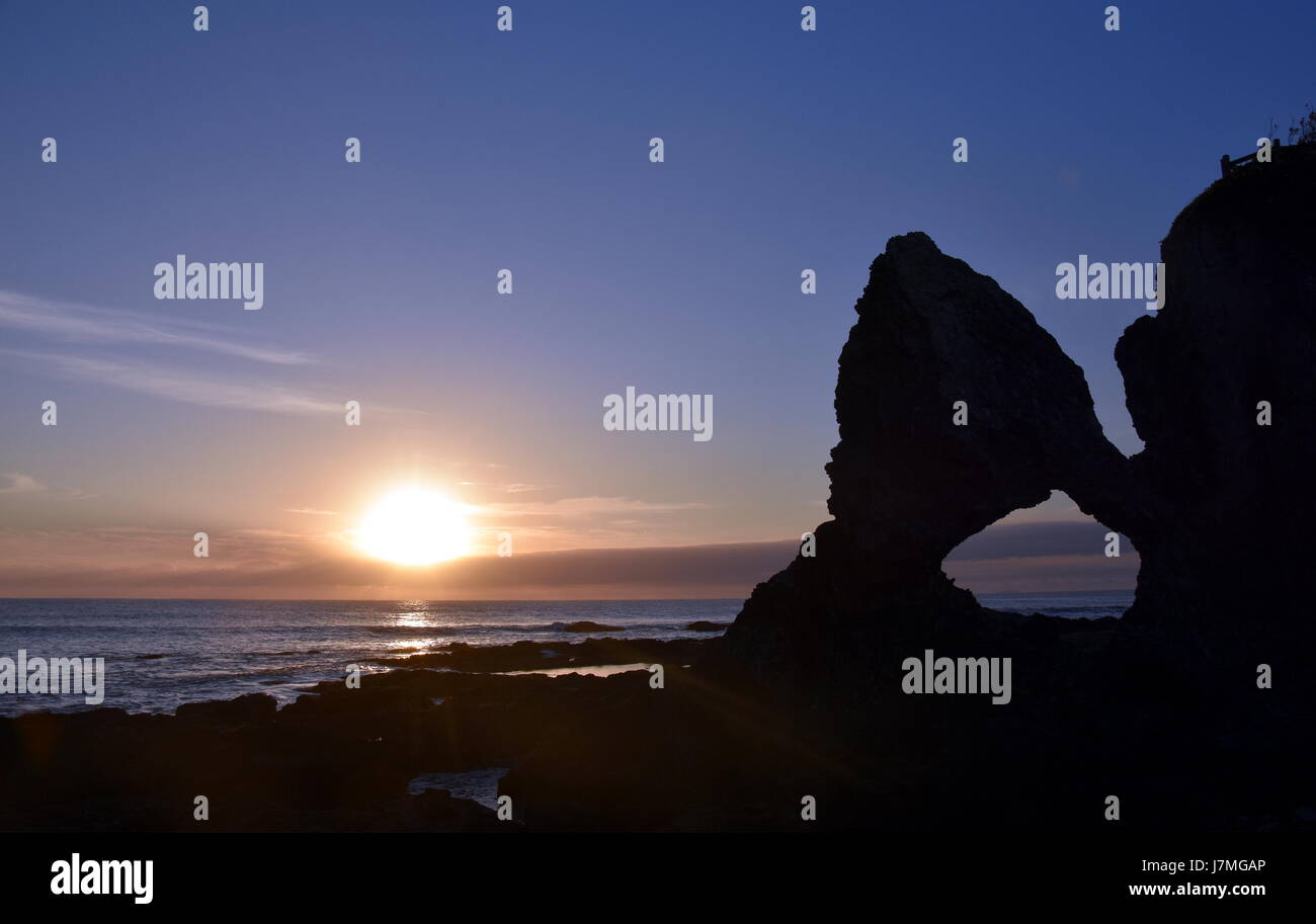 Sunrise at Australia rock in Narooma. The shape of Australia cut into ...