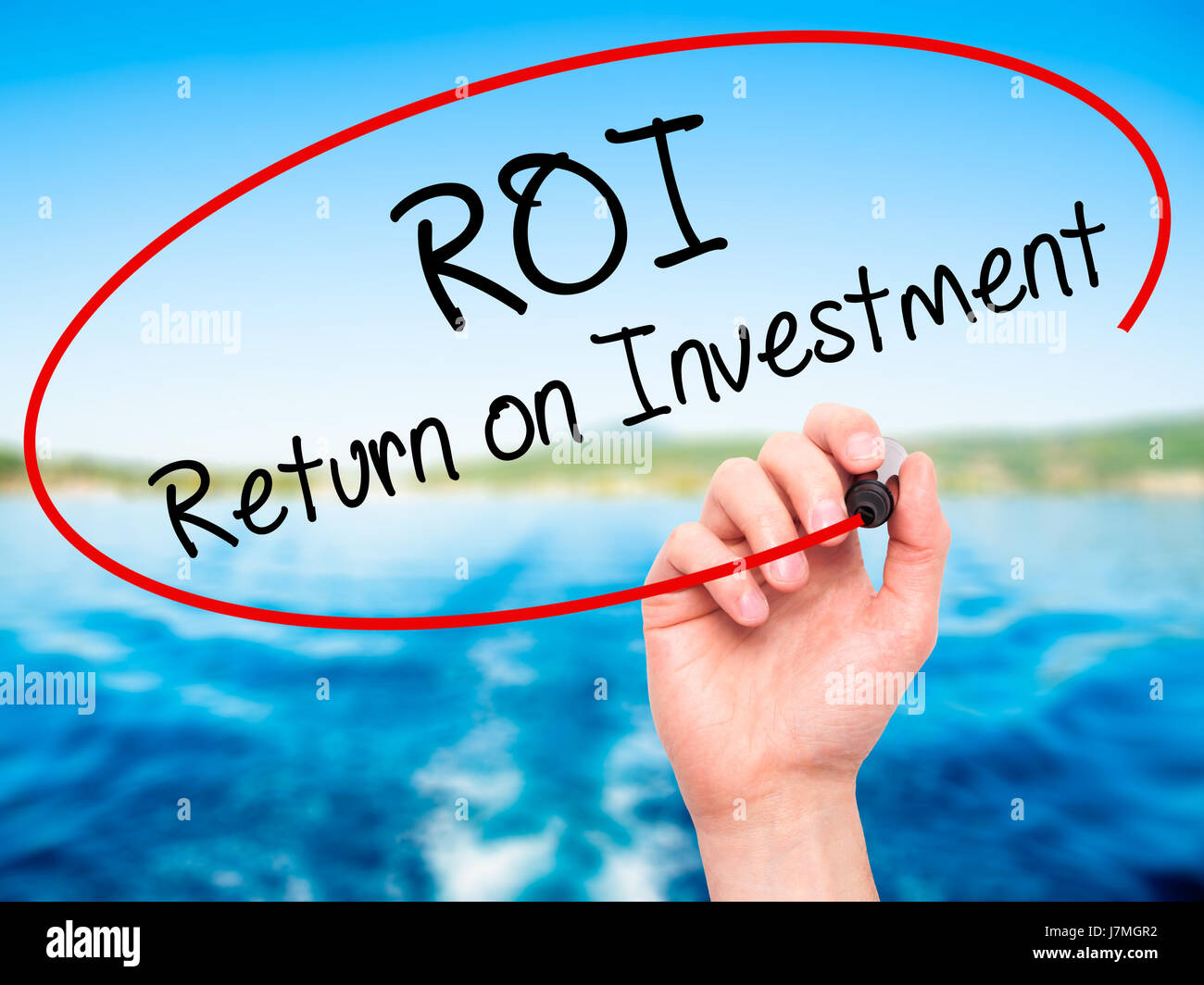 Man Hand writing ROI Return on Investment with black marker on visual ...