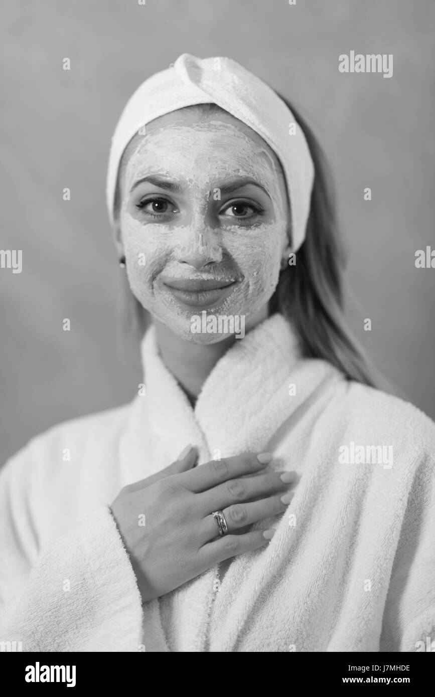 Spa Woman applying Facial Mask Beauty Treatments Close up portrait of ...