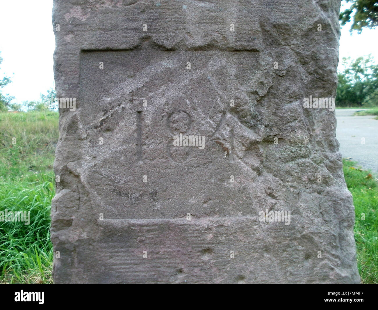 This image depicts a boundary stone (Grenzstein) located between ...
