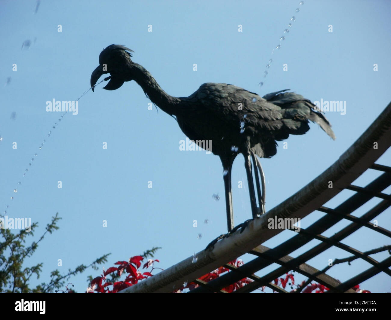 The photo captures a water-spouting bird statue at Schwetzingen Palace ...