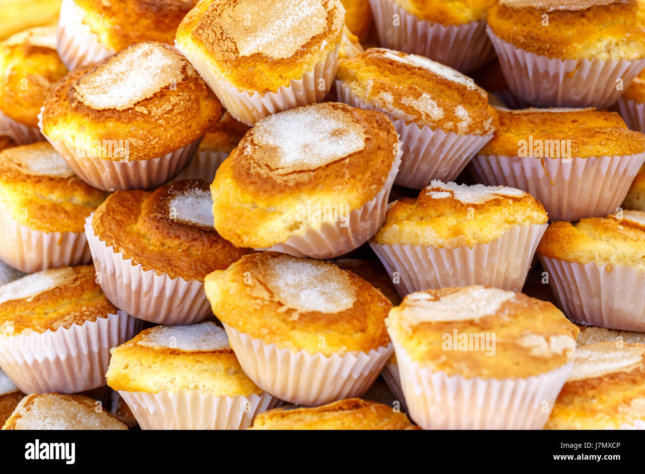 Pile of delicious baked muffins background Stock Photo - Alamy