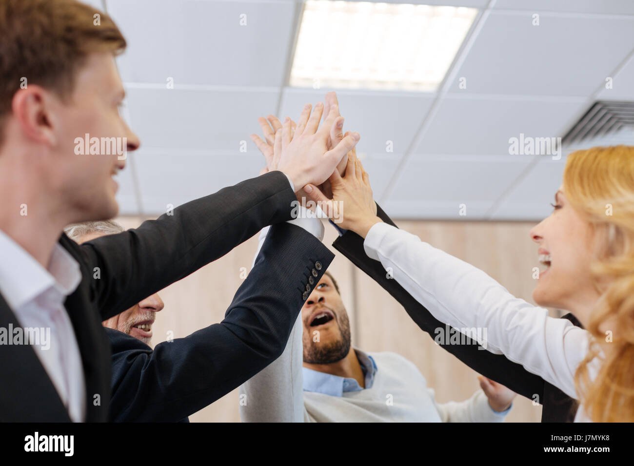 Happy positive people giving high five Stock Photo - Alamy