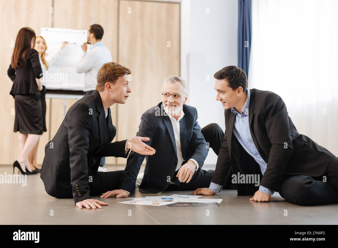 Nice positive businessmen having a conversation Stock Photo - Alamy