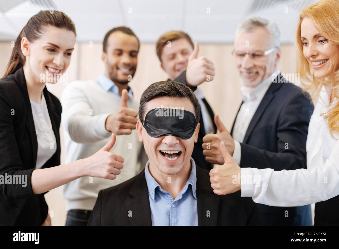 Delighted positive people supporting their colleague Stock Photo - Alamy