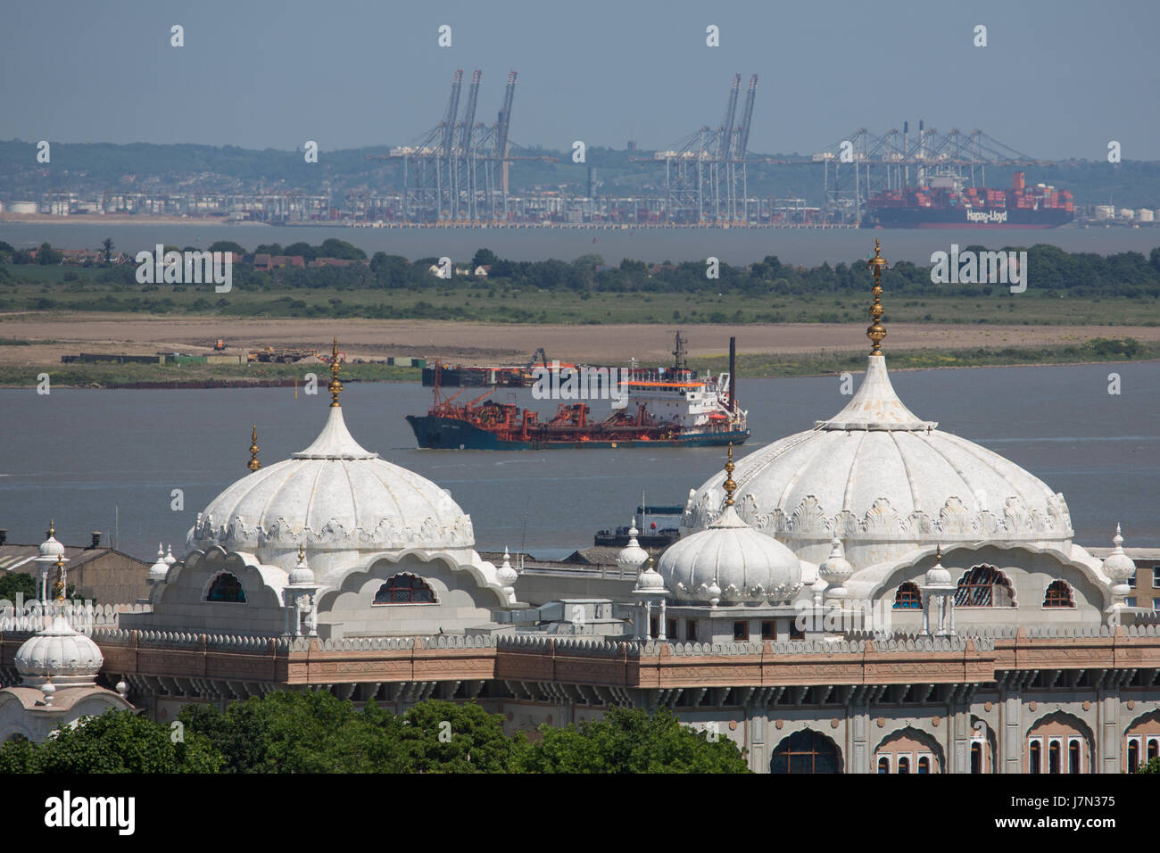 Gravesend, Kent, UK. 25th May, 2017. A ship sails past a Sikh temple in ...